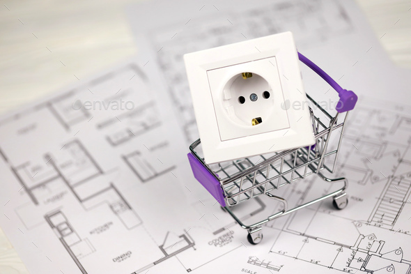 European standard EU outlet in small shopping cart on blueprints of ...