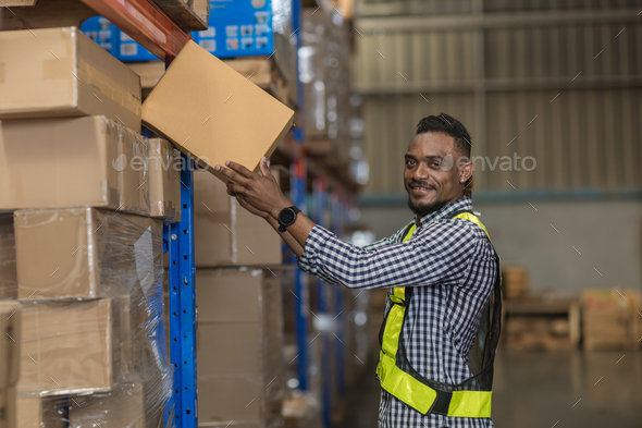 Warehouse worker working in warehouse storage. Stock Photo by kckate16