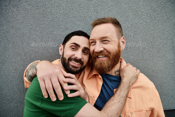 Embracing souls: two men hugging in unity Stock Photo by LightFieldStudios