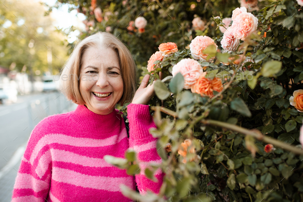 Happy laughing mature woman with roses Stock Photo by morrowlight ...