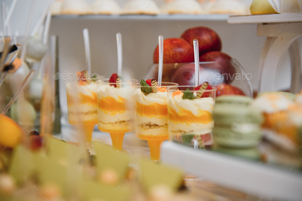 Different types of sweet pastries, small colorful sweet cakes, macaron ...