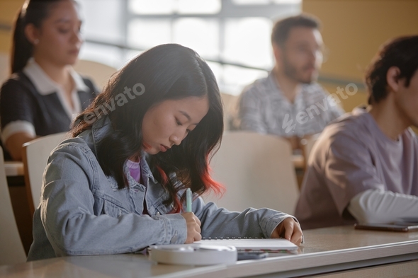 Focused Female Student Note Taking during Lecture at College Stock ...