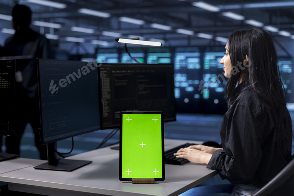 Admin in data center running system diagnostic tests using green screen ...
