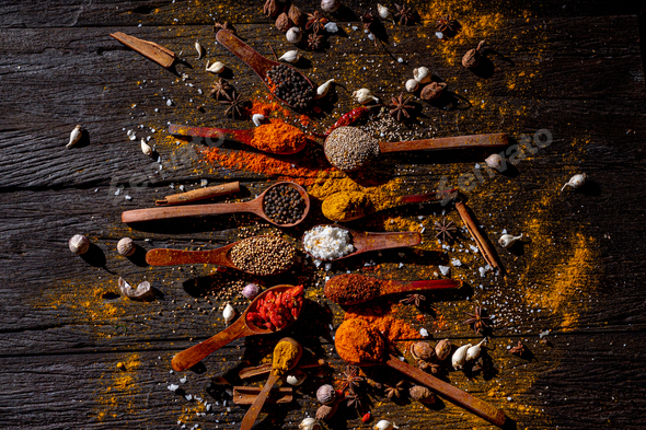 Colorful spices scattered across rustic wooden panels Stock Photo by ...