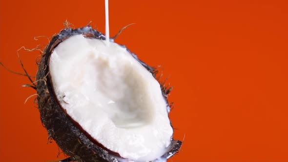 Drops of coconuts oil over red background, dripping coconut water ...