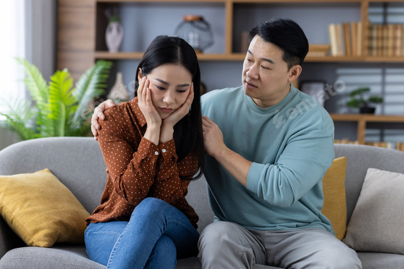 Husband supports upset wife at home, comfort and empathy shown Stock ...