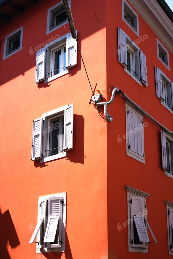 Facade and red painted wall of typical Italian buildings. Stock Photo ...
