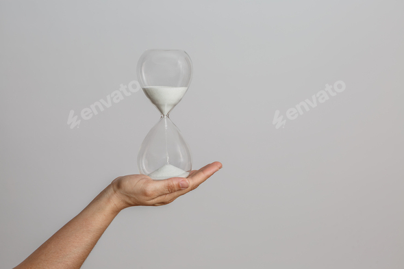 Hand Holding Sand Timer Against Neutral Background Signifying Time ...