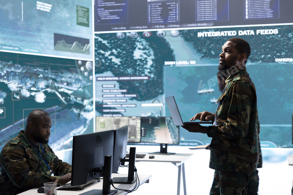 Military control room features army personnel monitoring surveillance ...