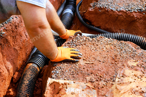Process of assembling drainage pipes for outflow of rain water a storm ...