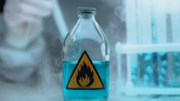 Bottle With Blue Inflammable Liquid in Lab, Scientist Conducting ...