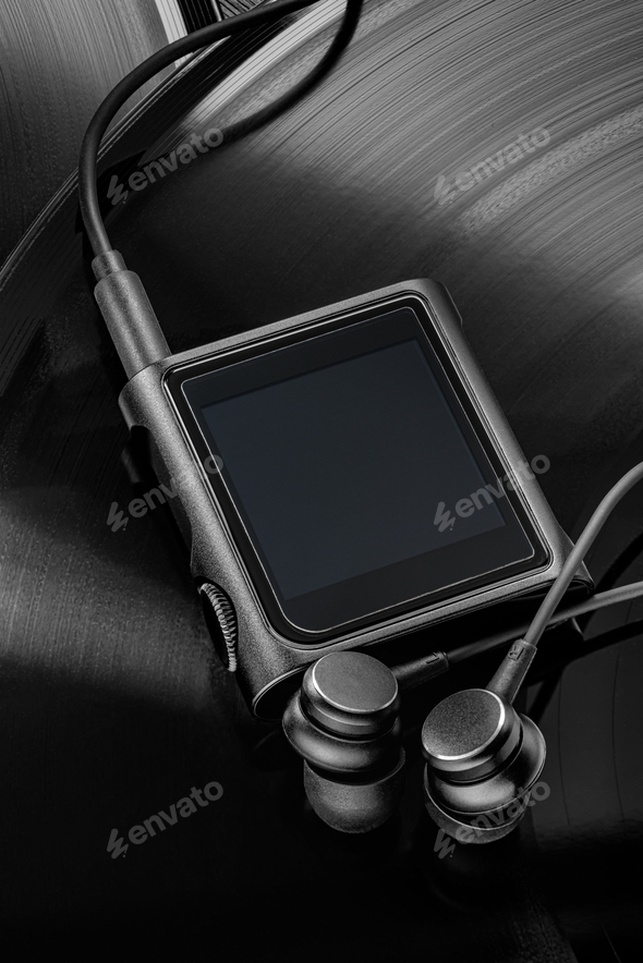 Modern black MP3 music player with empty screen on vinyl records with ...