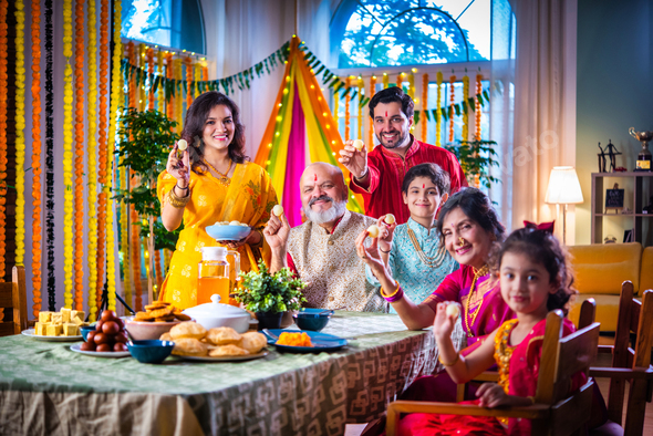 Portrait of happy Indian family in traditional outfit celebrating ...