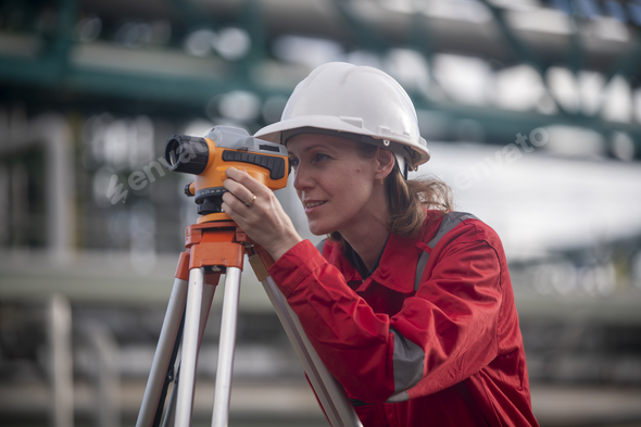 Surveyor engineers team wearing safety uniform and blueprint checking ...