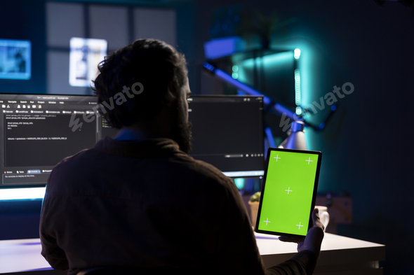 Cybersecurity expert using green screen tablet to look for malware ...