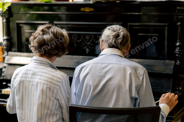 elderly people sitting at the piano together playing a melody learning ...