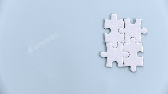 Four Jigsaw Puzzle Pieces Interlocking: Symbolizing Teamwork and ...