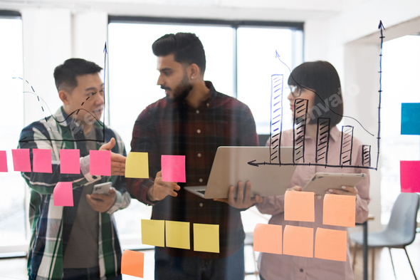 Business team brainstorming ideas with sticky notes and charts Stock ...