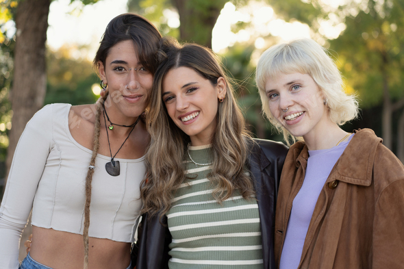 Diverse group of young women friends smiling outdoors - Friendship and ...
