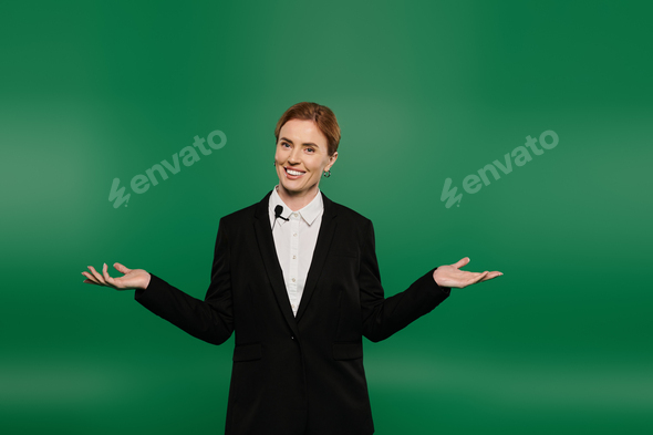 Elegant TV presenter engaging viewers from a vibrant green backdrop in ...