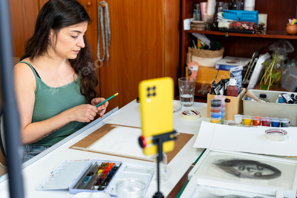 Female illustrator drawing in pencil in her art studio Stock Photo by ...