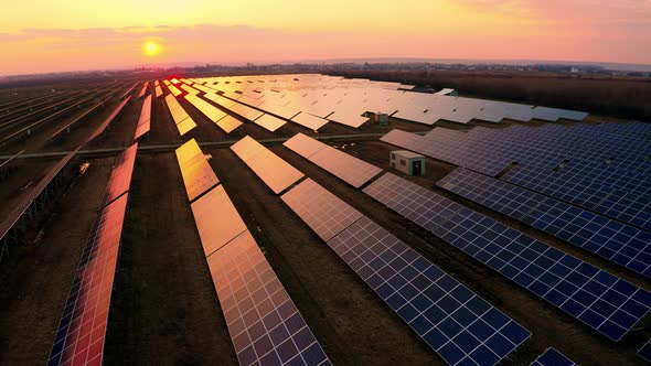Aerial Top view of a Solar Power Station at Sunset. Flying from above ...