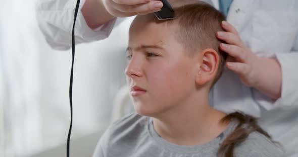 Close Up of Medical Staff Shaving Sick Kid with Hair Clipper in ...