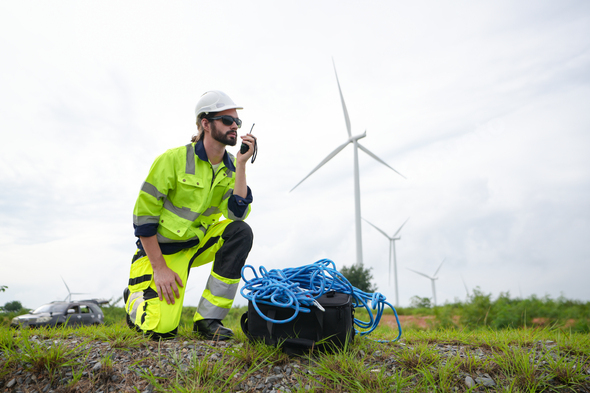 Windturbine inspector wearing Personal protective equipment working at ...