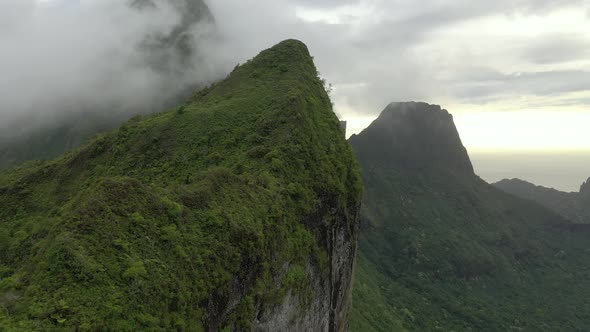 Aerial flying sideways over an exuberant mountain ridge with a dramatic ...
