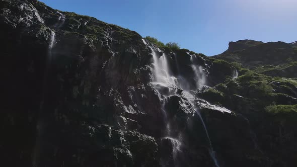 Water Flows Down the Slope of a Mountain Drops Splash From a Huge Rock ...