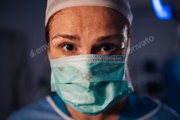 Medical professional in surgical attire standing in an operating room ...