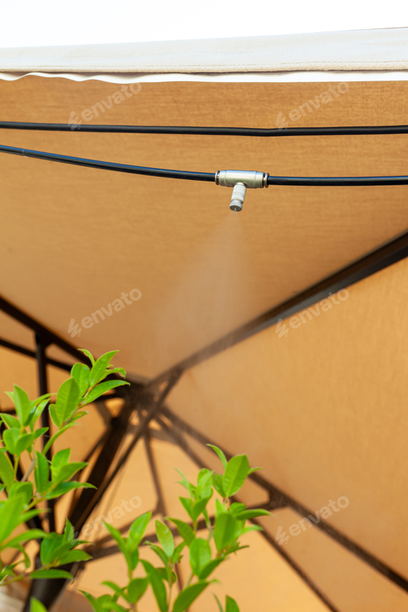Water misting system refreshing the air under awning Stock Photo by ...