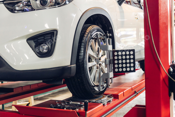 Car wheel centering machine adjustment. Stock Photo by kckate16 | PhotoDune