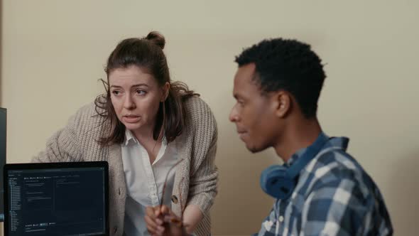 Database Developer Analyzing Compiling Code on Multiple Screens Takes Off Glasses and Doing High ...