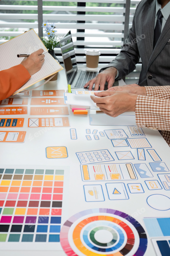 Creative Team Collaborates On Ux Ui Design Project With Color Palettes And Wireframes In Modern