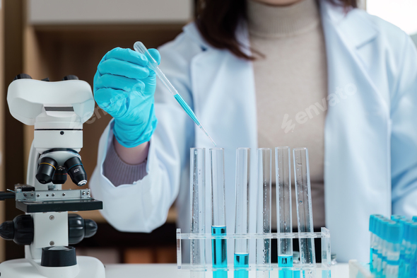 Scientist Conducting Experiment in Modern Laboratory with Test Tubes ...