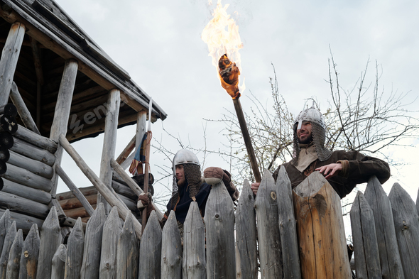 Guarding Fort with Flaming Torch and Wooden Fence Stock Photo by ...
