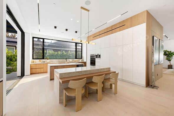 Modern kitchen with natural light, wooden cabinets, and a sleek design ...