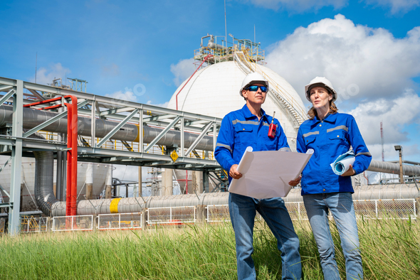 Team Petroleum chemical engineer discussion about blueprint drawings ...