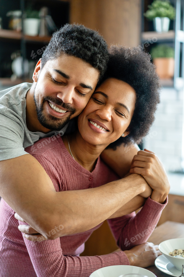 Portrait of happy smiling black couple in love having fun and hugging together Stock Photo by nd3000