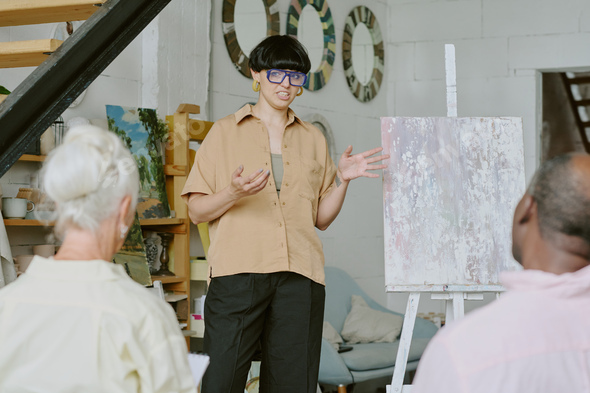 Female Teacher Explaining Drawing Technique Stock Photo by AnnaStills