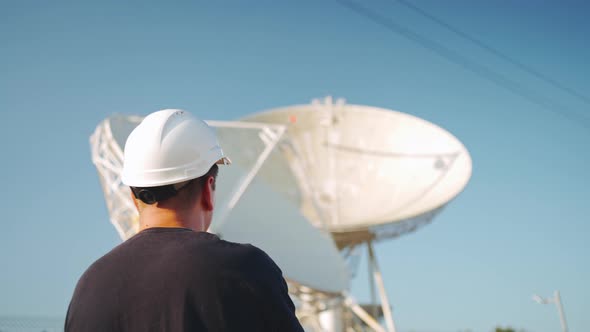 Engineer Looking Earth Based Astronomical Radio Telescope, Stock Footage