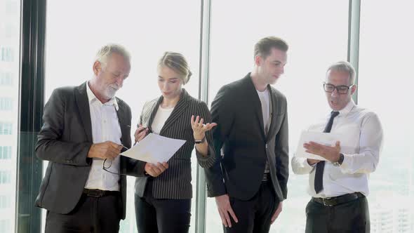Group of employee standing discussion planning work in the office ...