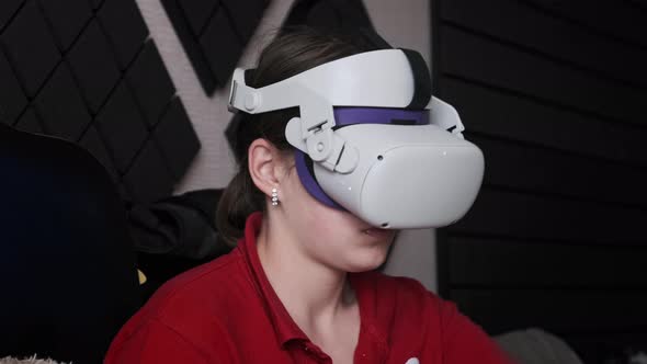 Young Woman in VR Helmet Sitting on Sofa and Communicating in Virtual ...
