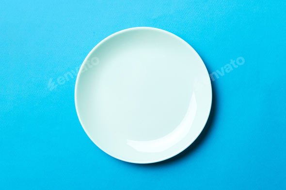 Top view of isolated of colored background empty round blue plate for ...