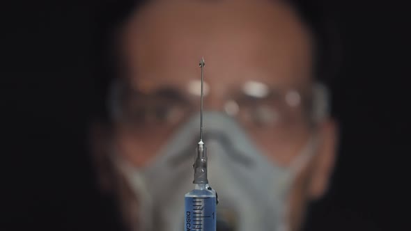 Doctor Holds the Syringe in His Hand and Presses the Valve To Release ...