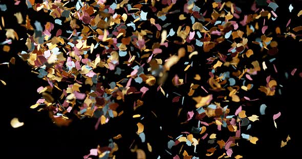 Confettis Falling against Black Background, Slow Motion 4K, Stock Footage