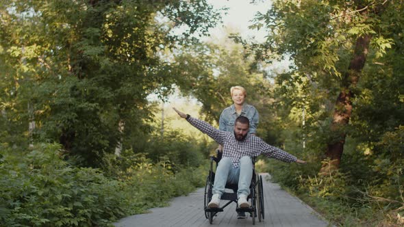Joyful Cheerful Disabled Caucasian Man in Wheelchair is Having Fun with ...