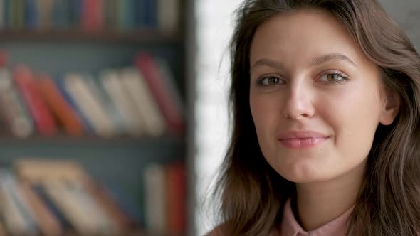 close up portrait of young pretty librarian woman smiling happy looking ...