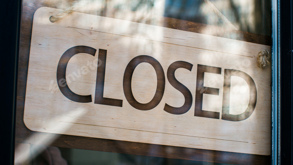 Close-up man waiter salesman turning signboard from closed to open on ...